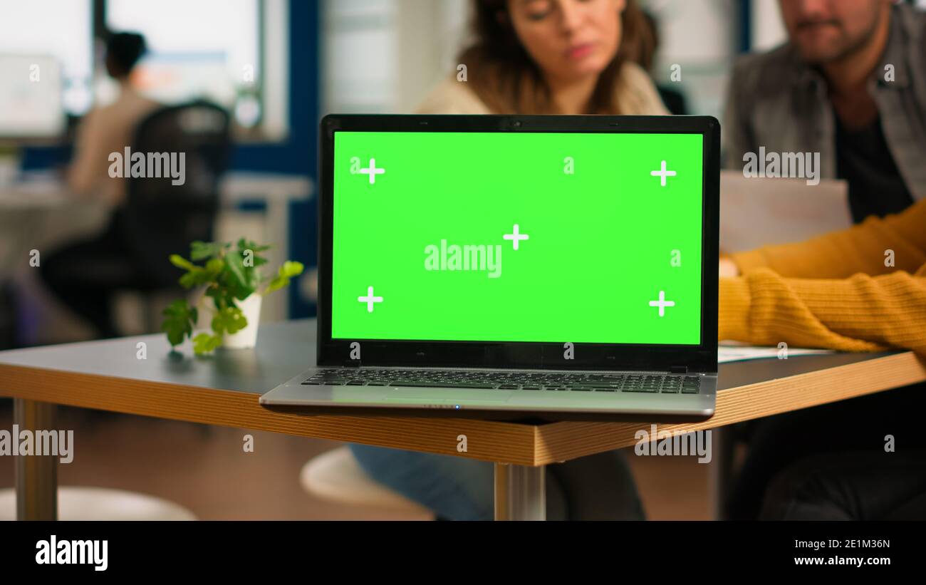 Businesspeople analysing annual financial reports sitting at desk in ...