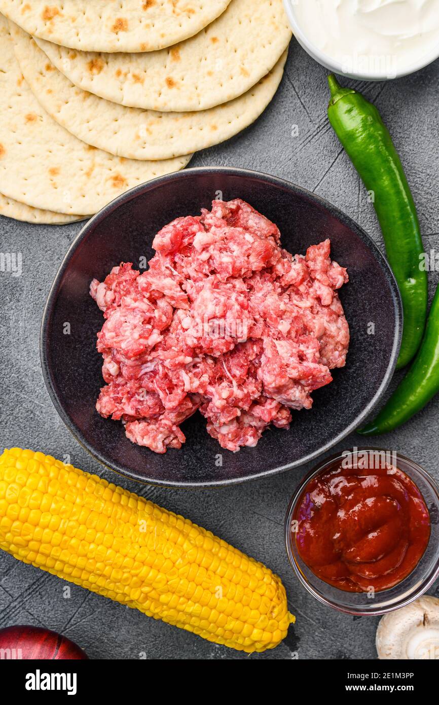 Minced meat for mexican cusine with ingredients in black bowl, over ...