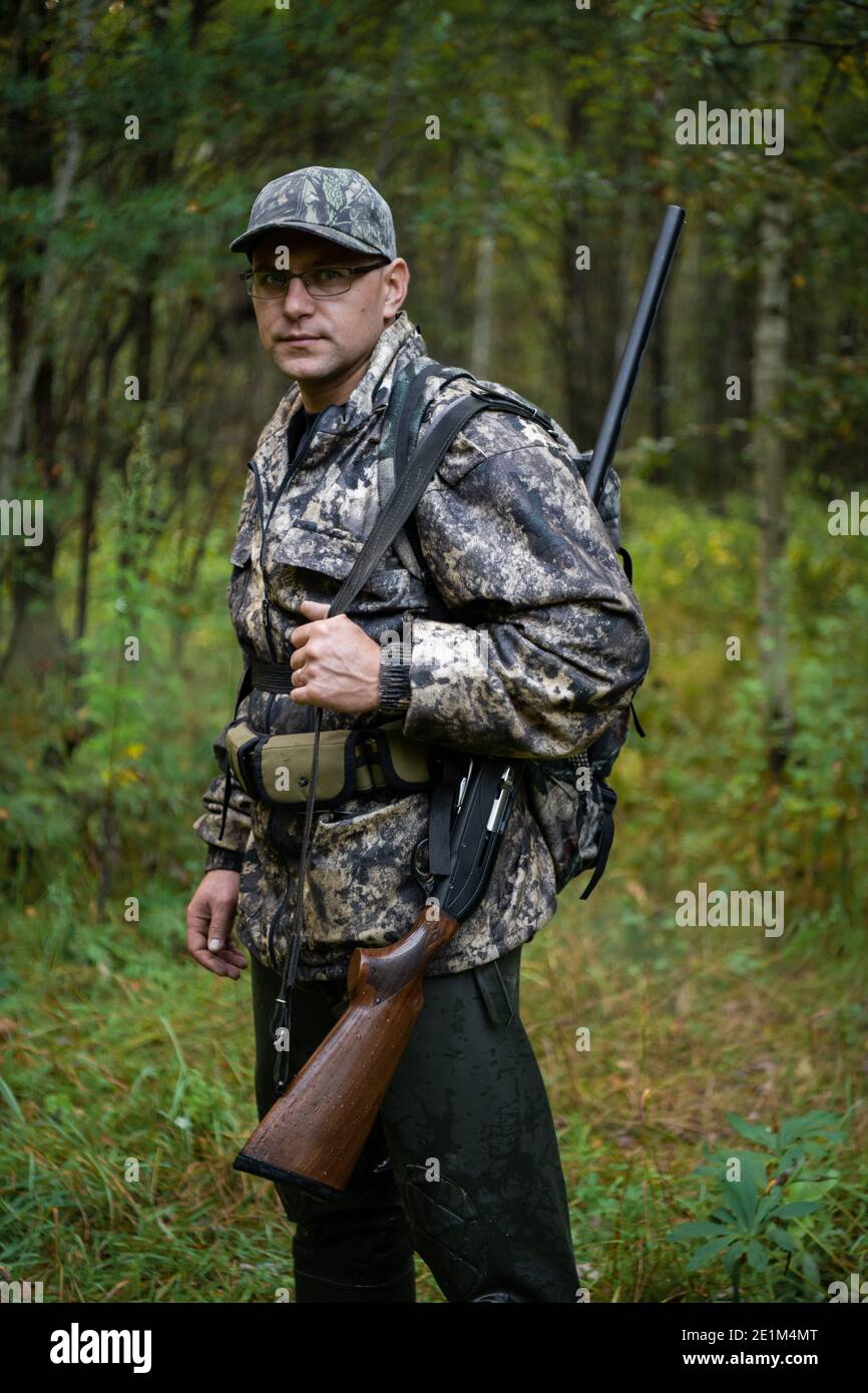 Man hunter standing with shotgun rifle outdoors preparing for bird hunt ...