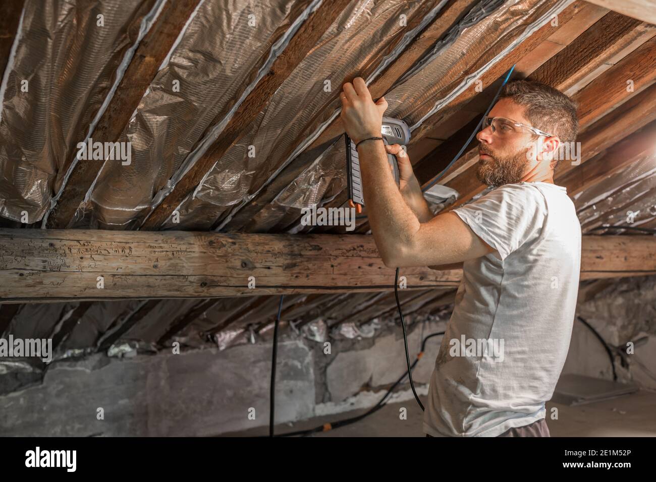 House roof insulation work Stock Photo - Alamy