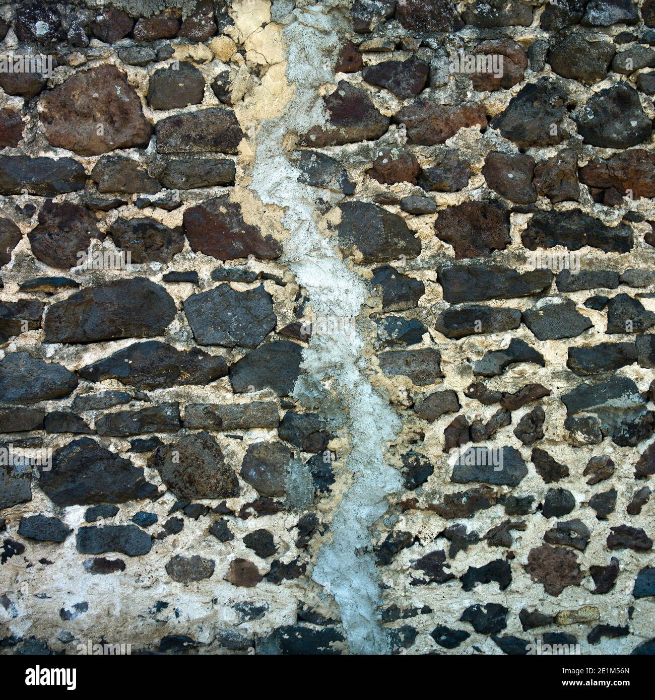 Cracked wall. Unique textured stone wall displays the effects of time ...