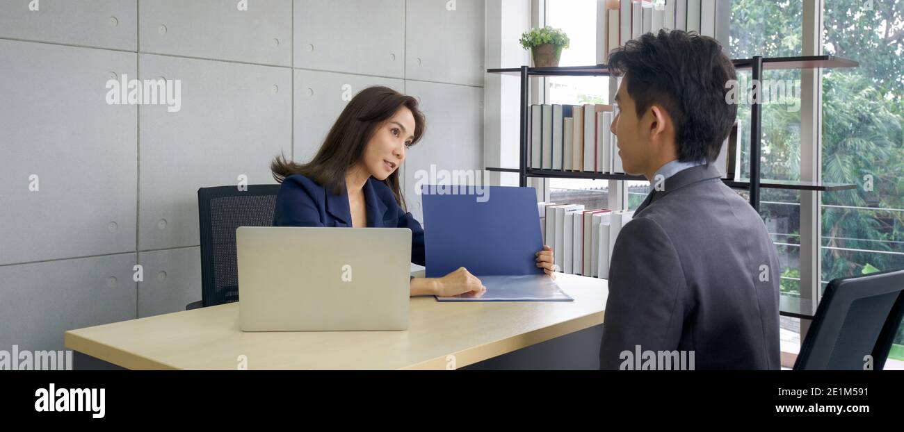 ํYoung asian manager in the blue suit interviewed the applicant. The ...