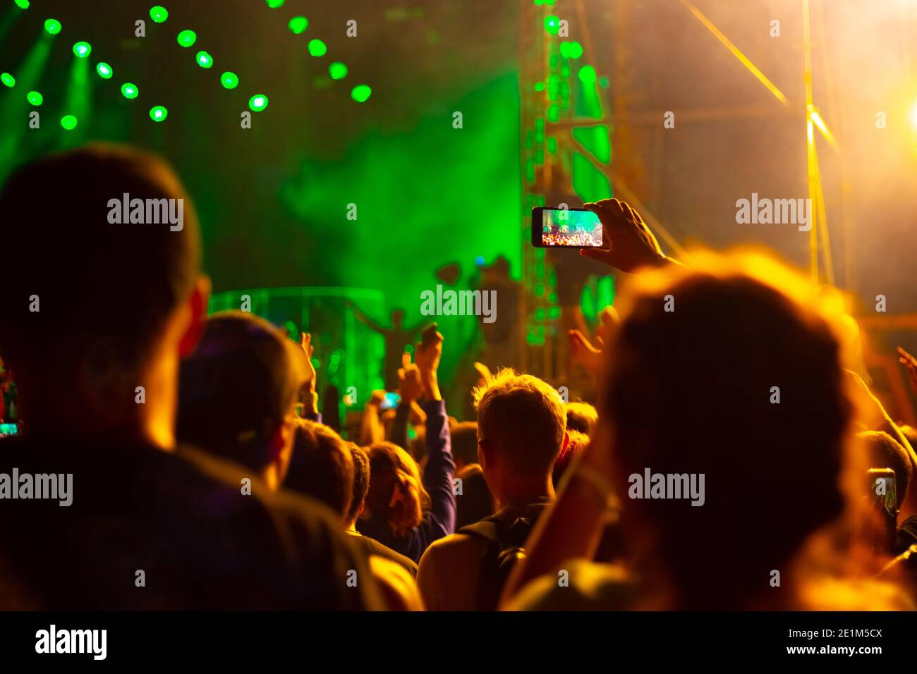 crowd of fans raise their hands up and dance in a nightclub, shoot on ...