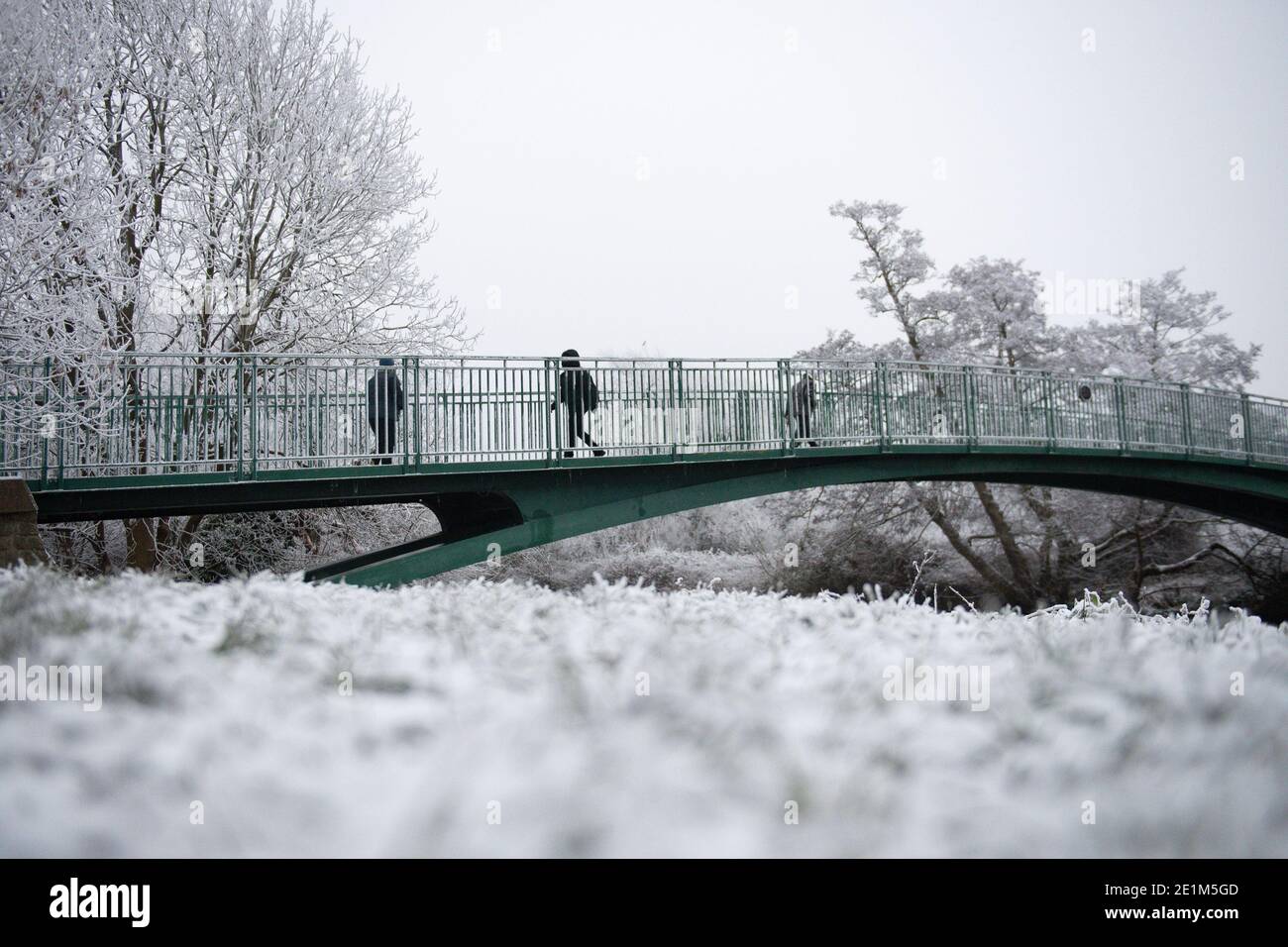 People walk through the snow-covered St Nicholas' Park, in Warwick ...