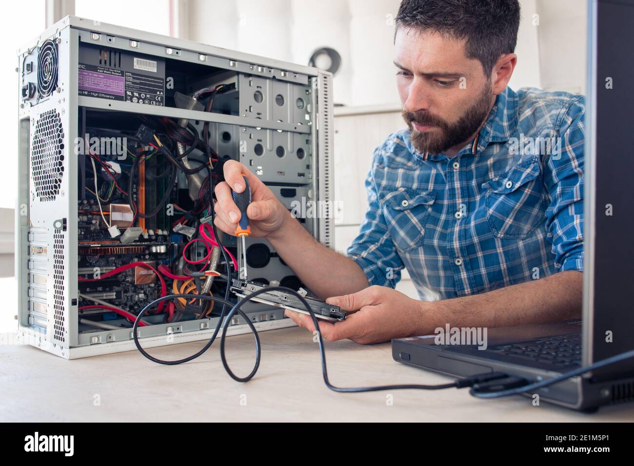 Engineer repairs computer's hard drive Stock Photo - Alamy