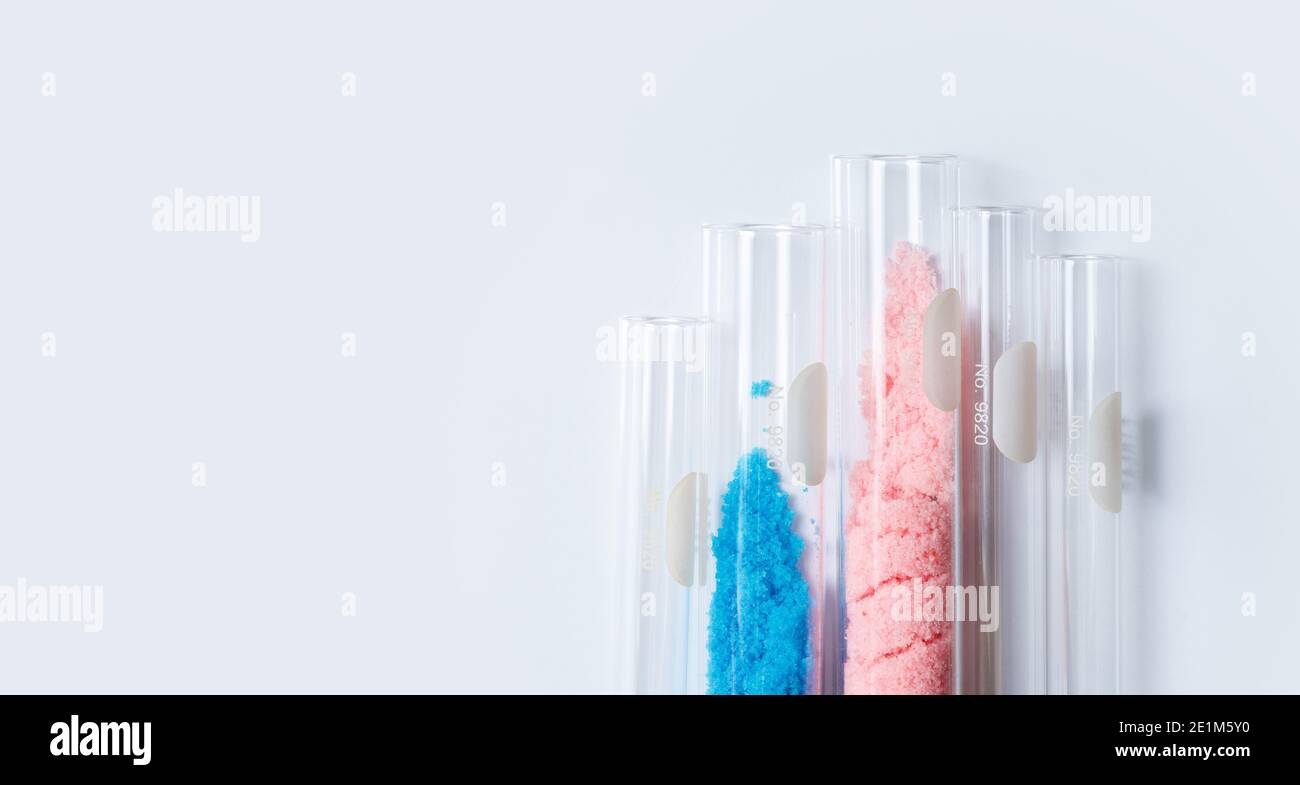 Pink flake chemicals and Copper(II) sulfate in test tube. Cosmetic ...
