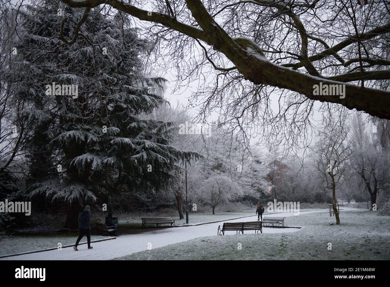 People walk through the snow-covered St Nicholas' Park, in Warwick ...