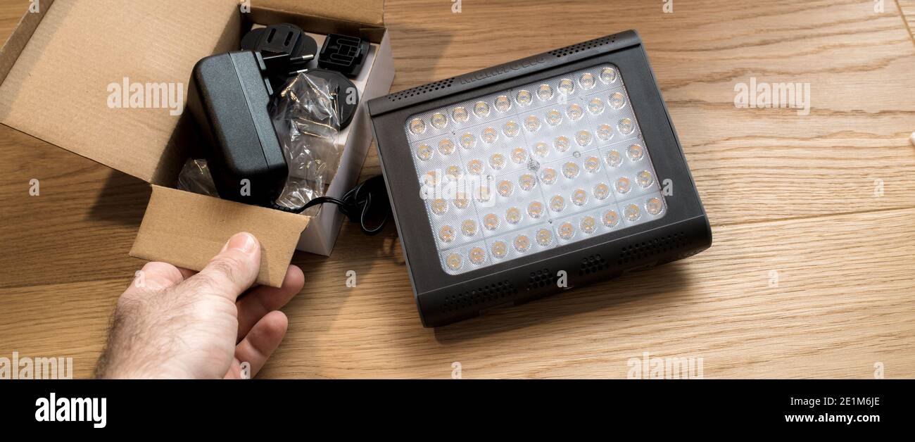 Paris, France - Dec 8 2020: POV male hand unboxing unpacking new ...