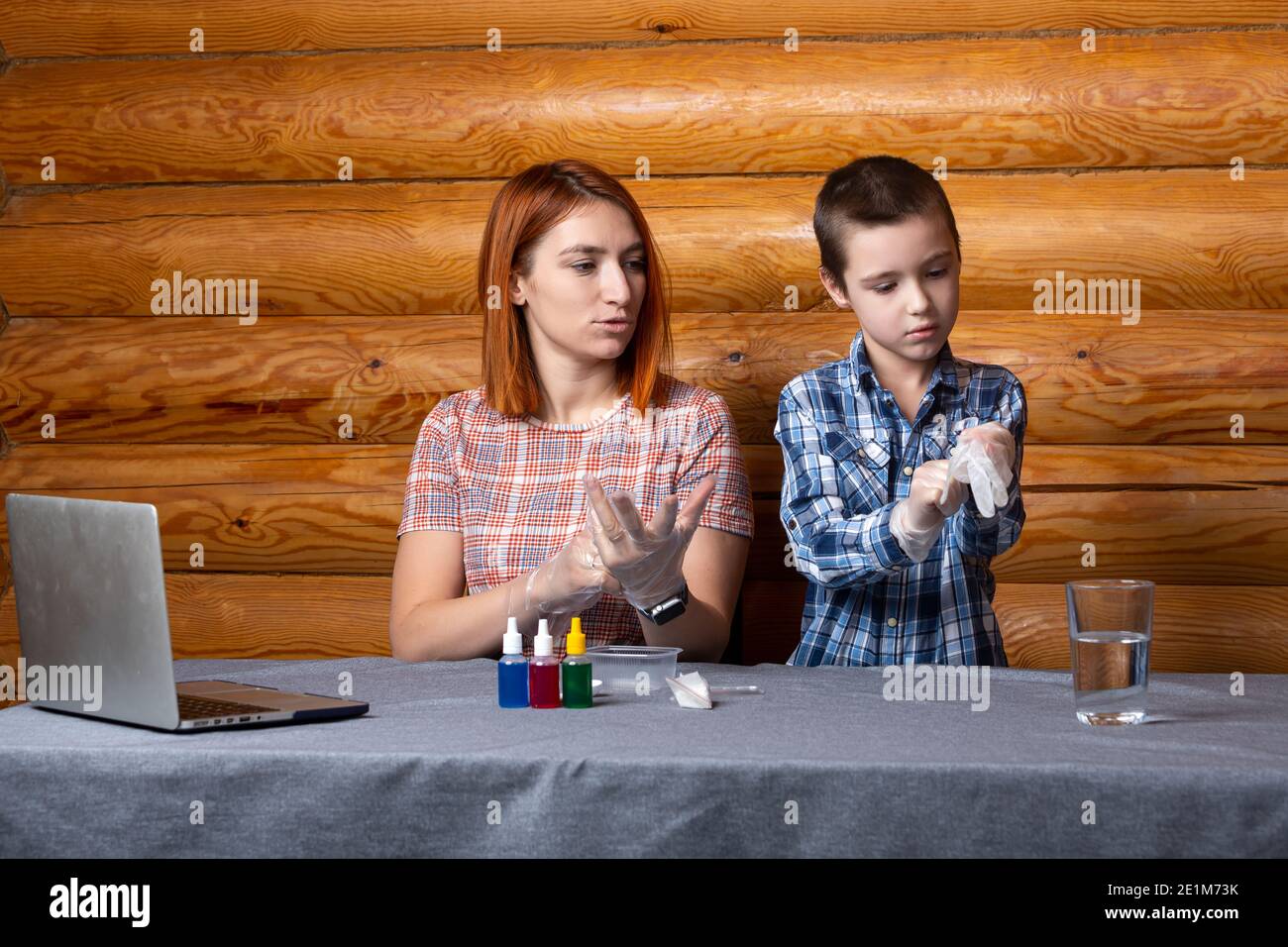 Little boy and mom put on disposable surgical gloves and get ready to ...