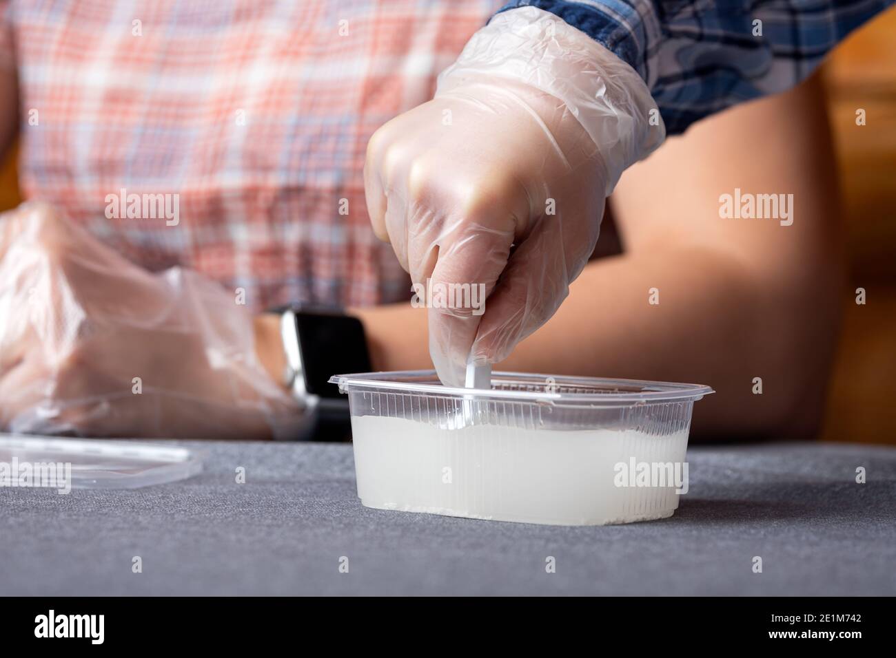 Chemistry education and study concept. Close-up of a boy stirring a ...
