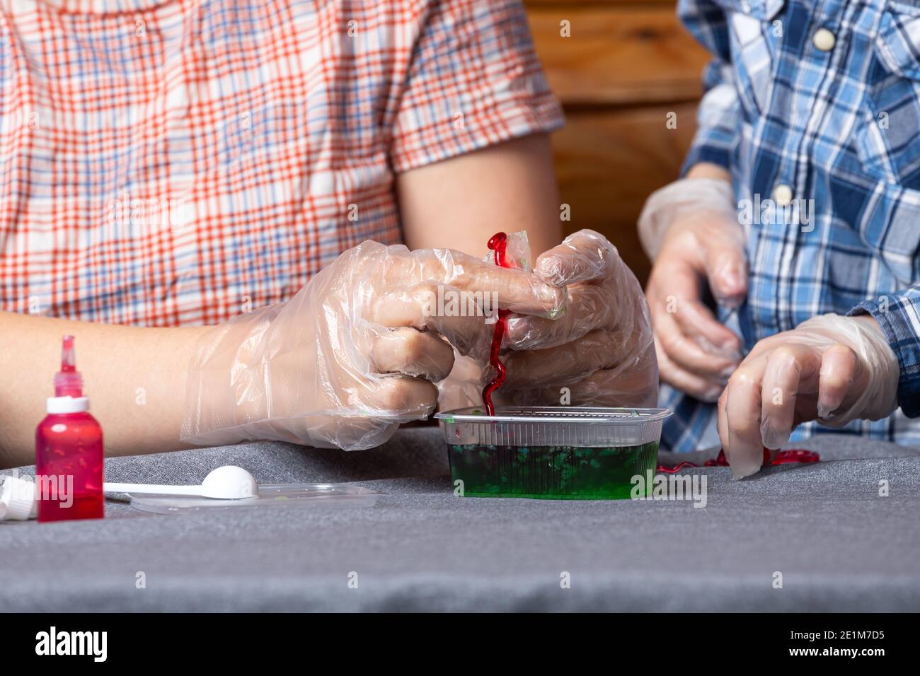 Chemical experiments with a child. Mom and her son make polymer worms ...