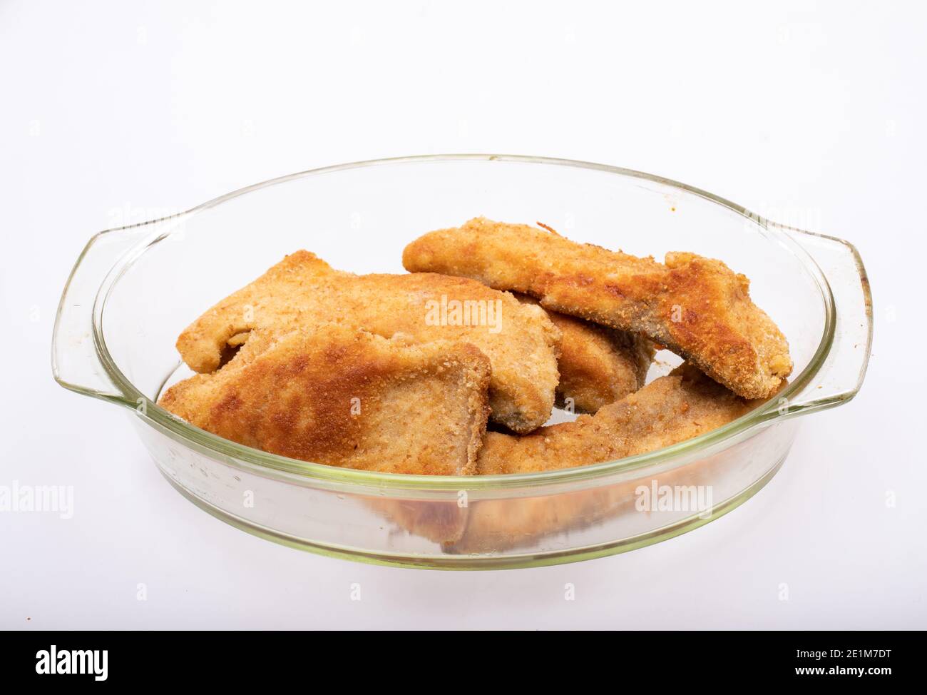 Breaded fish fillets in a glass, heat-resistant dish Stock Photo - Alamy