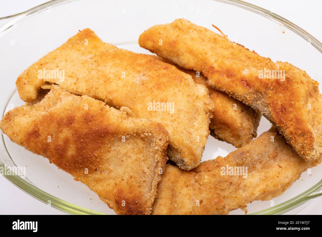 Breaded fish fillets in a glass, heat-resistant dish Stock Photo - Alamy