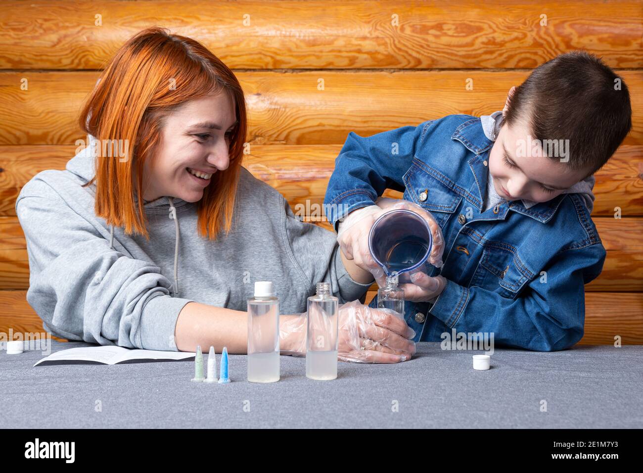 Chemistry education and study concept. Close-up of a boy and his mother ...