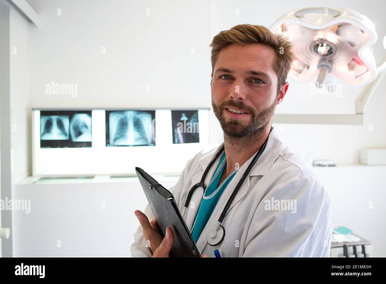 portrait of a young smiling doctor isolated on blurred medical ...