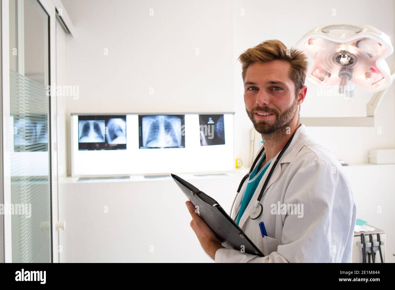 portrait of a young smiling doctor isolated on blurred medical ...