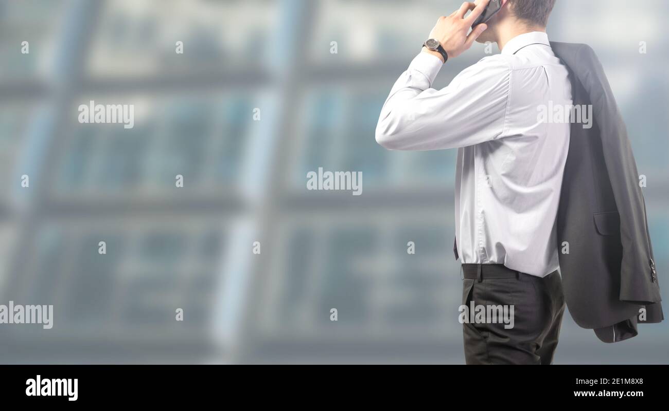 Business man working alone on laptop or with files, in background ...