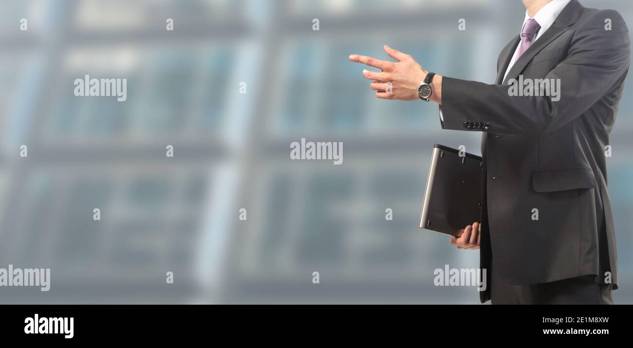 Business man working alone on laptop or with files, in background ...