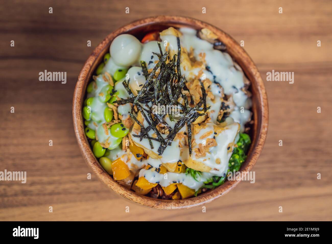 Raw Organic Poke Bowl with Rice and Veggies close-up on the table. Top ...