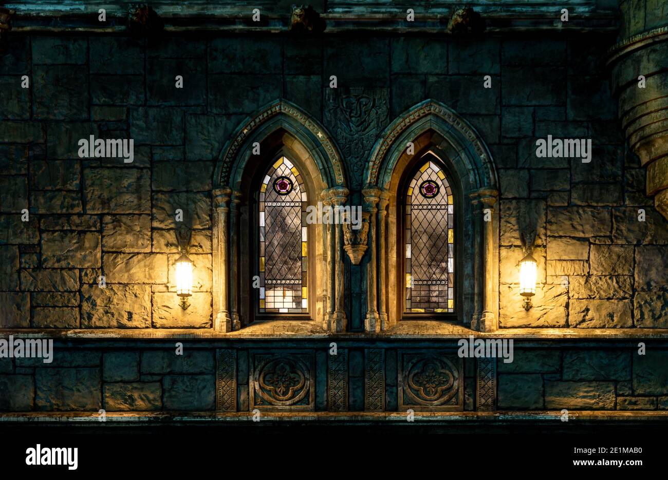 stained glass windows of a stone castle lit by dim lanterns, selective ...
