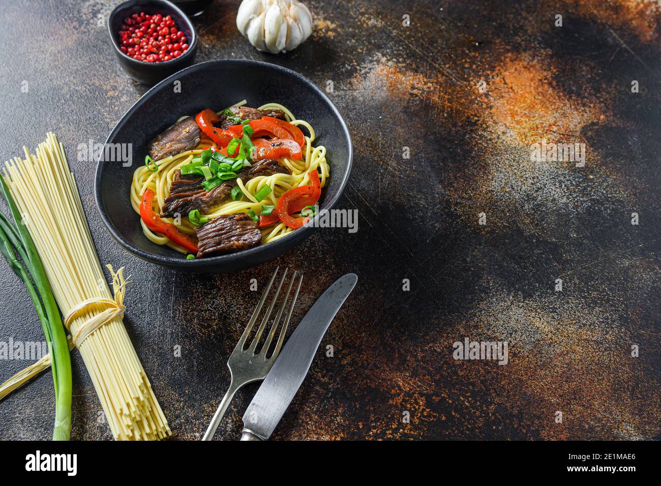 Wok with noodles and stir fry beef side view space for text Stock Photo ...