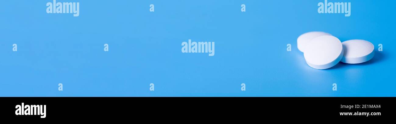 three anti-inflammatory pills on blue background. The concept of health ...