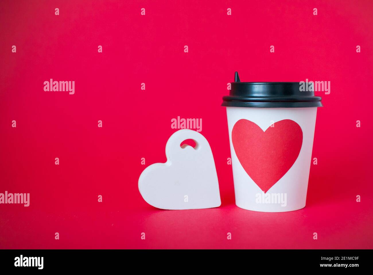 disposable paper cups with red heart on bright red background ...