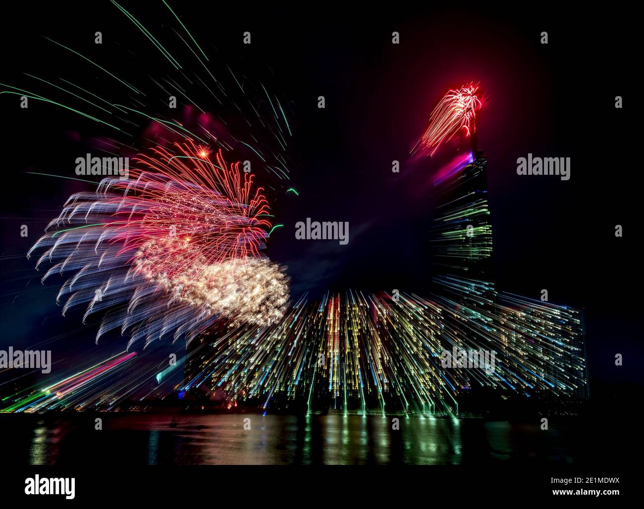 Colorful abstract fireworks next to the skyscraper architecture ...