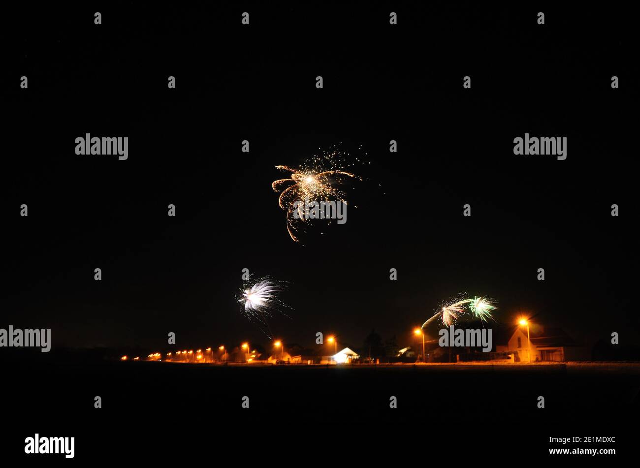 colorful fireworks in the night with street lighting Stock Photo - Alamy