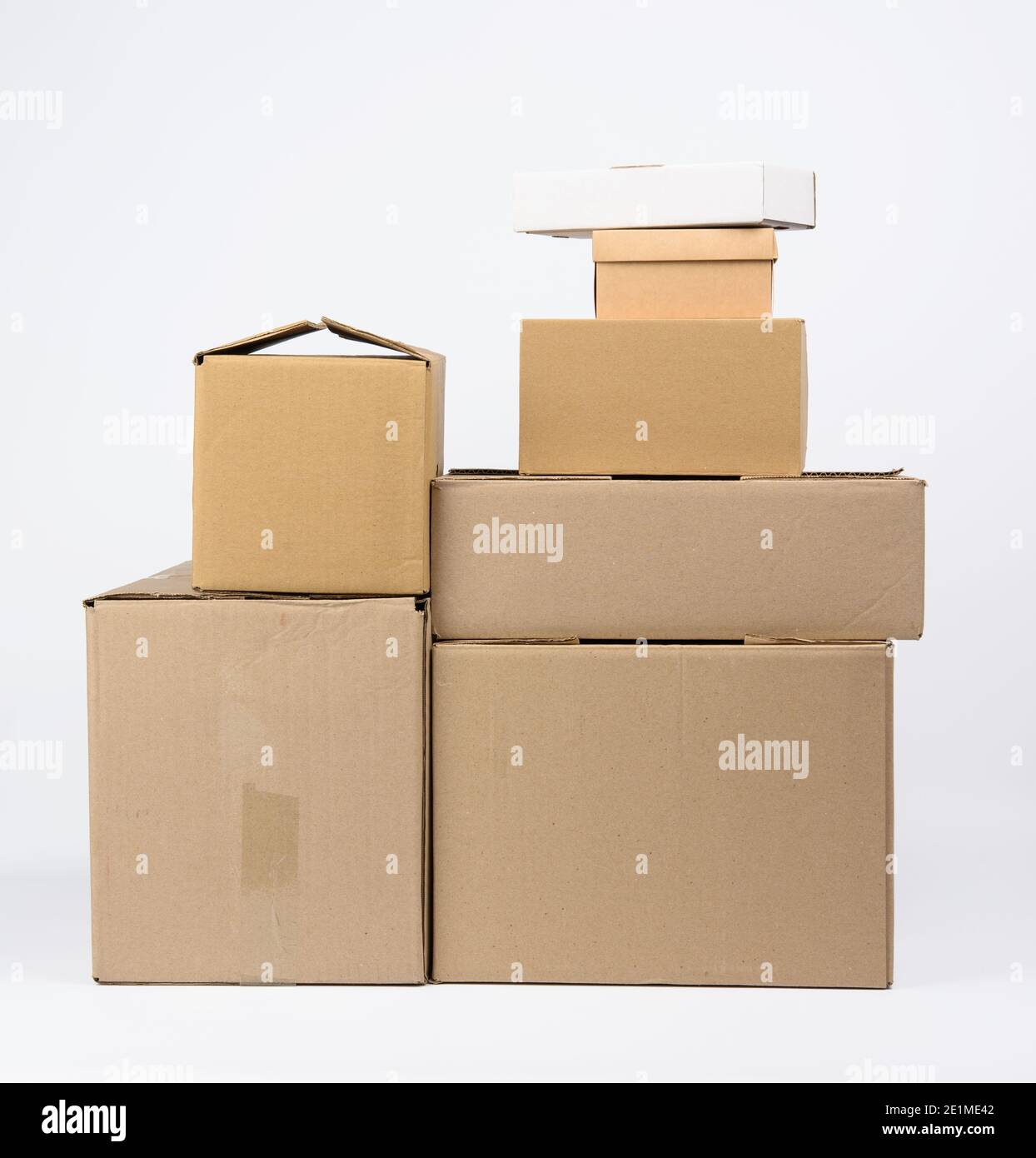 big stack of closed cardboard brown paper boxes on white background ...