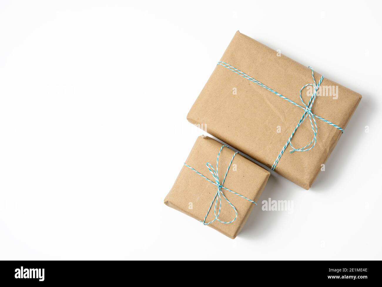 square box wrapped in brown kraft paper and tied with rope, gift on ...