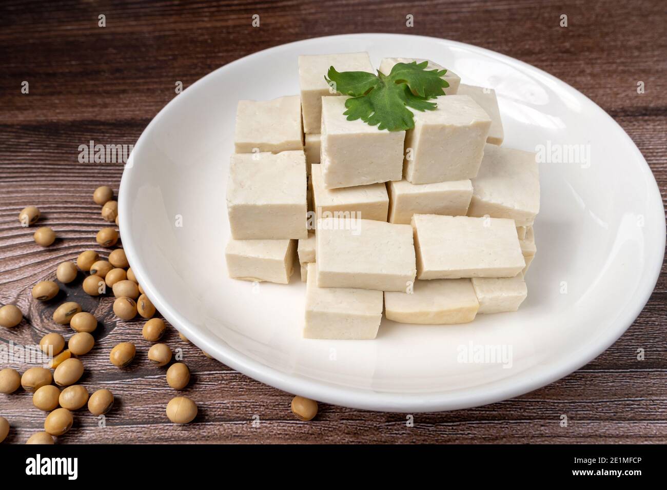 fresh diced tofu in white dish with soy bean. full depth of field ...