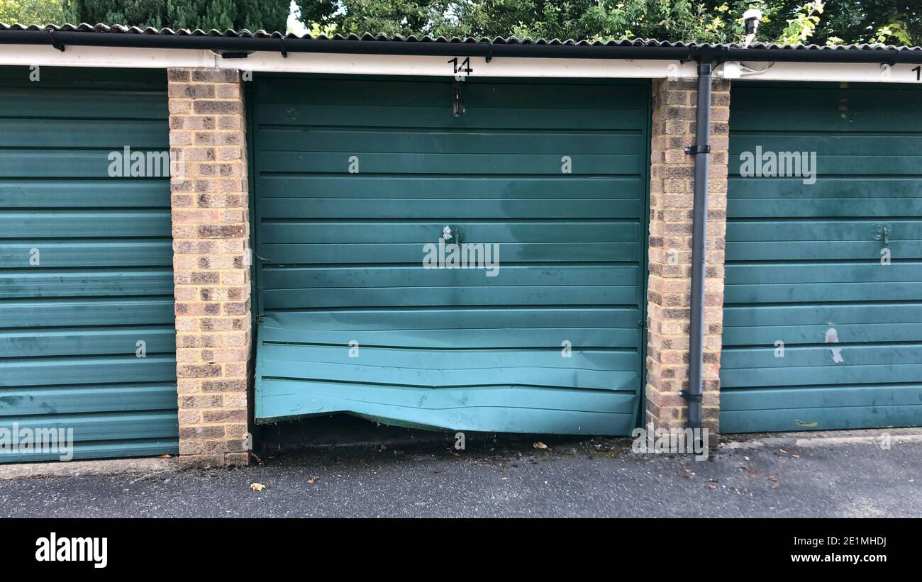 Garage doors forced open, break in damage Stock Photo - Alamy