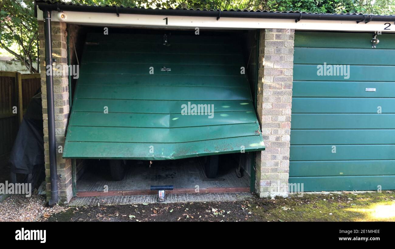 Garage doors forced open, break in damage Stock Photo - Alamy