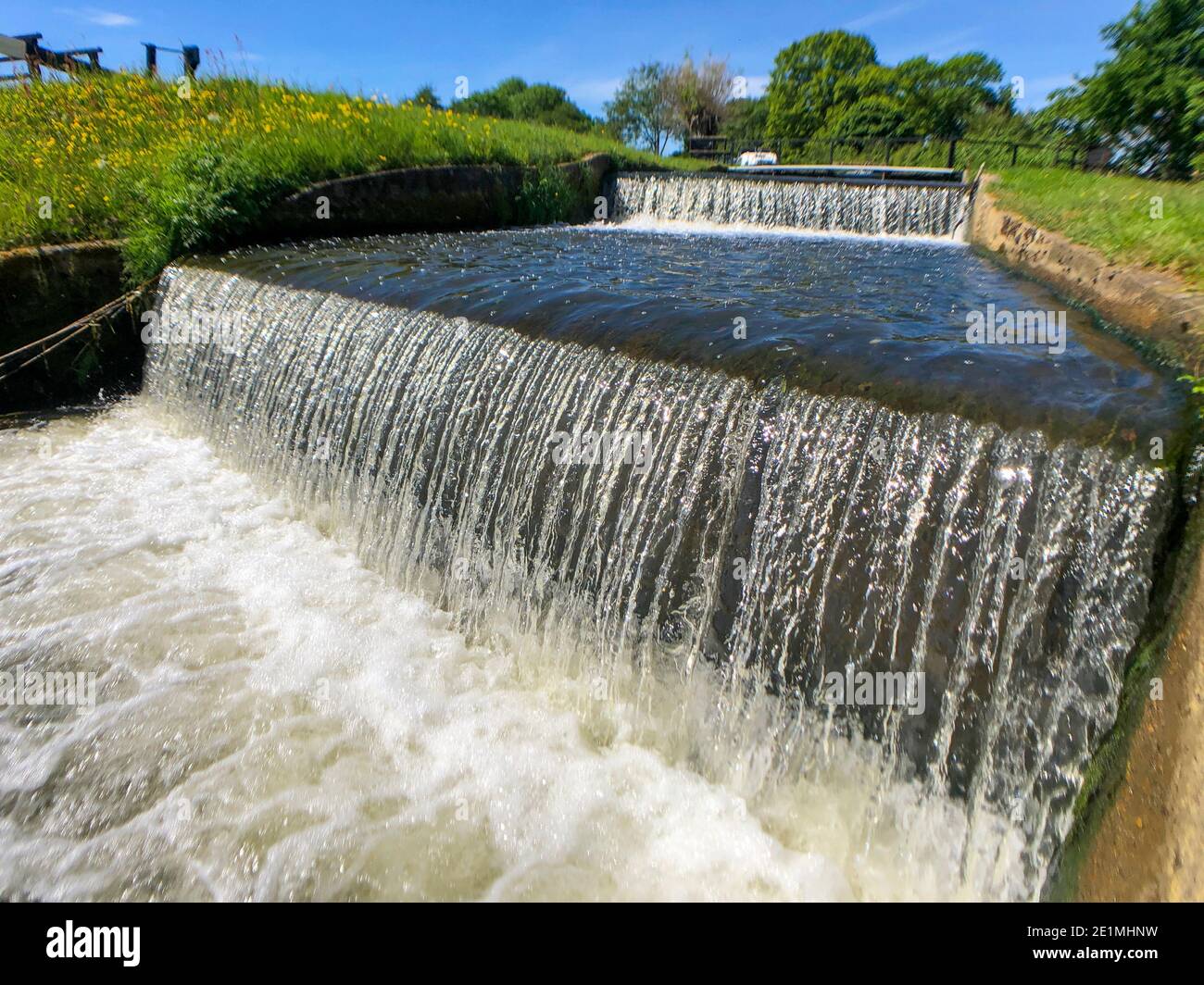 Lock keepers cottage by canal with small water fall blue sky Stock ...