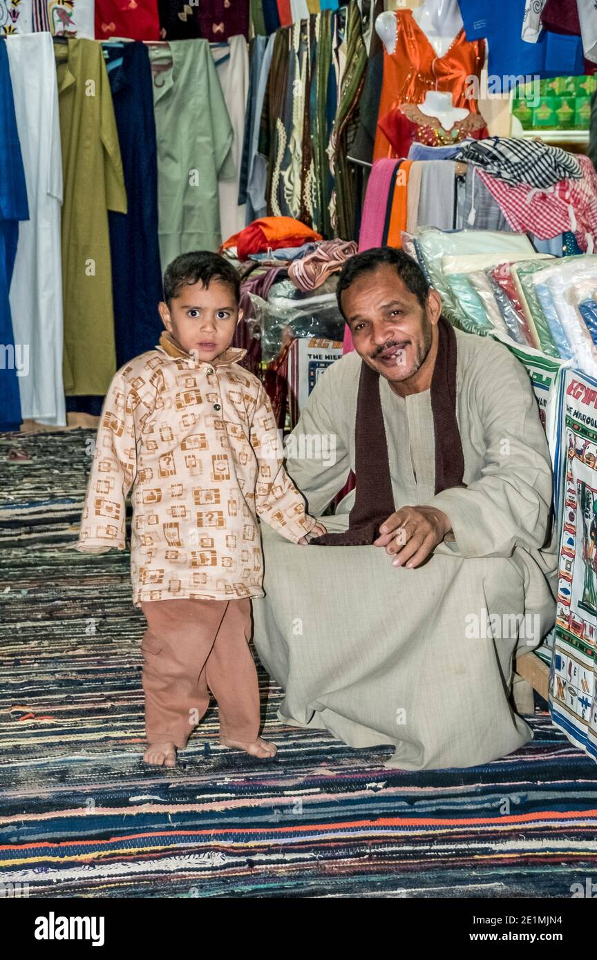 Colourful street scenes at a family store with father and son in the ...