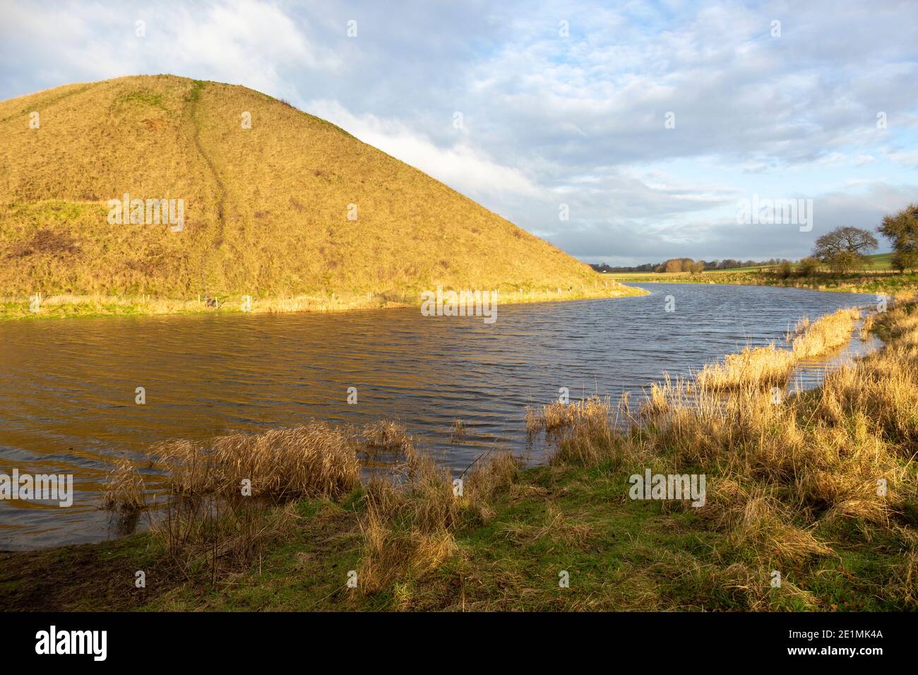 Water filled moat surrounding neolithic prehistoric mound of Silbury ...