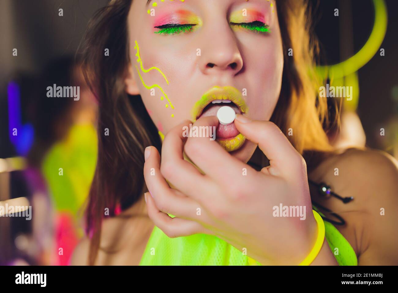beautiful girl with lsd on tongue in nightclub with pink smoke Stock ...