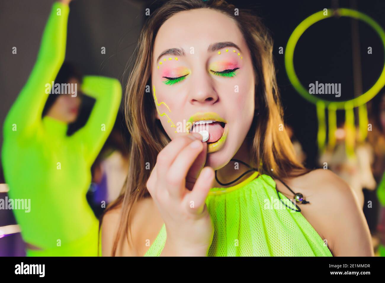 beautiful girl with lsd on tongue in nightclub with pink smoke Stock ...