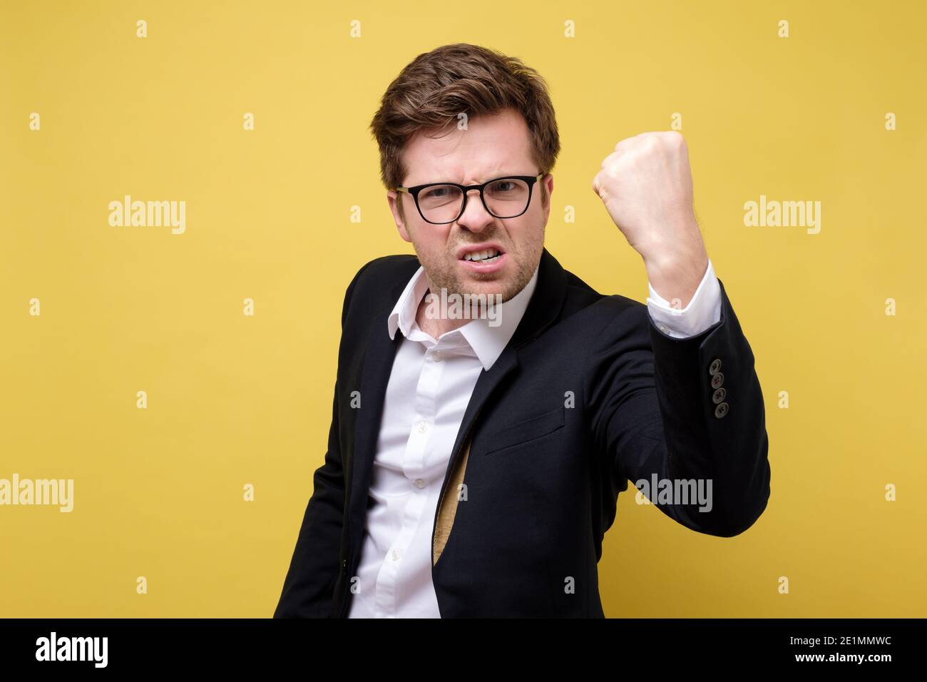 Handsome man being angry and mad raising fist frustrated and furious ...