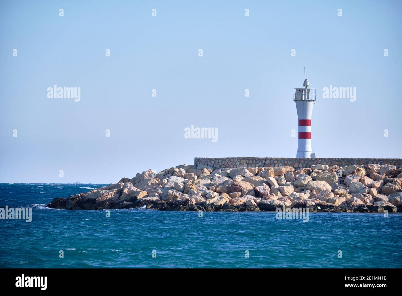 Lighthouse on the stone pier Stock Photo - Alamy