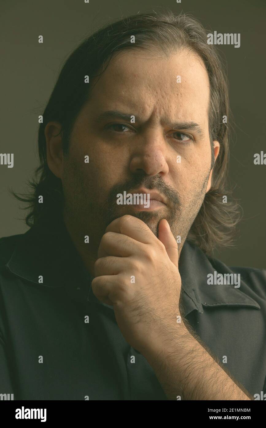 Face of fat Caucasian man thinking in the dark Stock Photo - Alamy