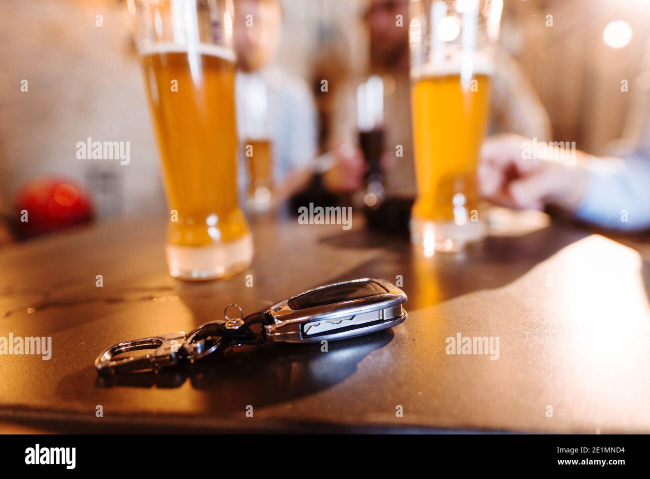 Car keys on desk. In background men drinking beer. Pub interior Stock ...