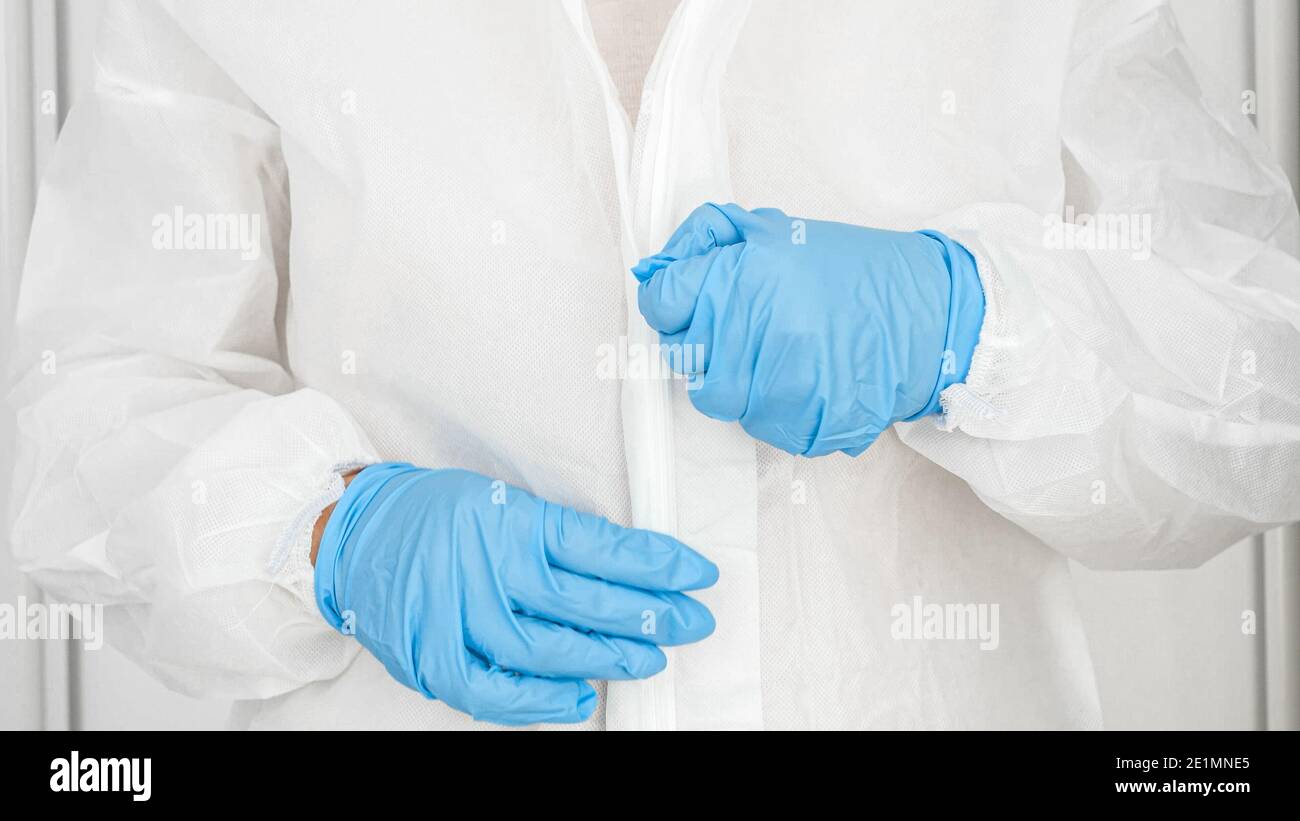 Closeup of female doctor of bacteriologist wearing and putting on ...