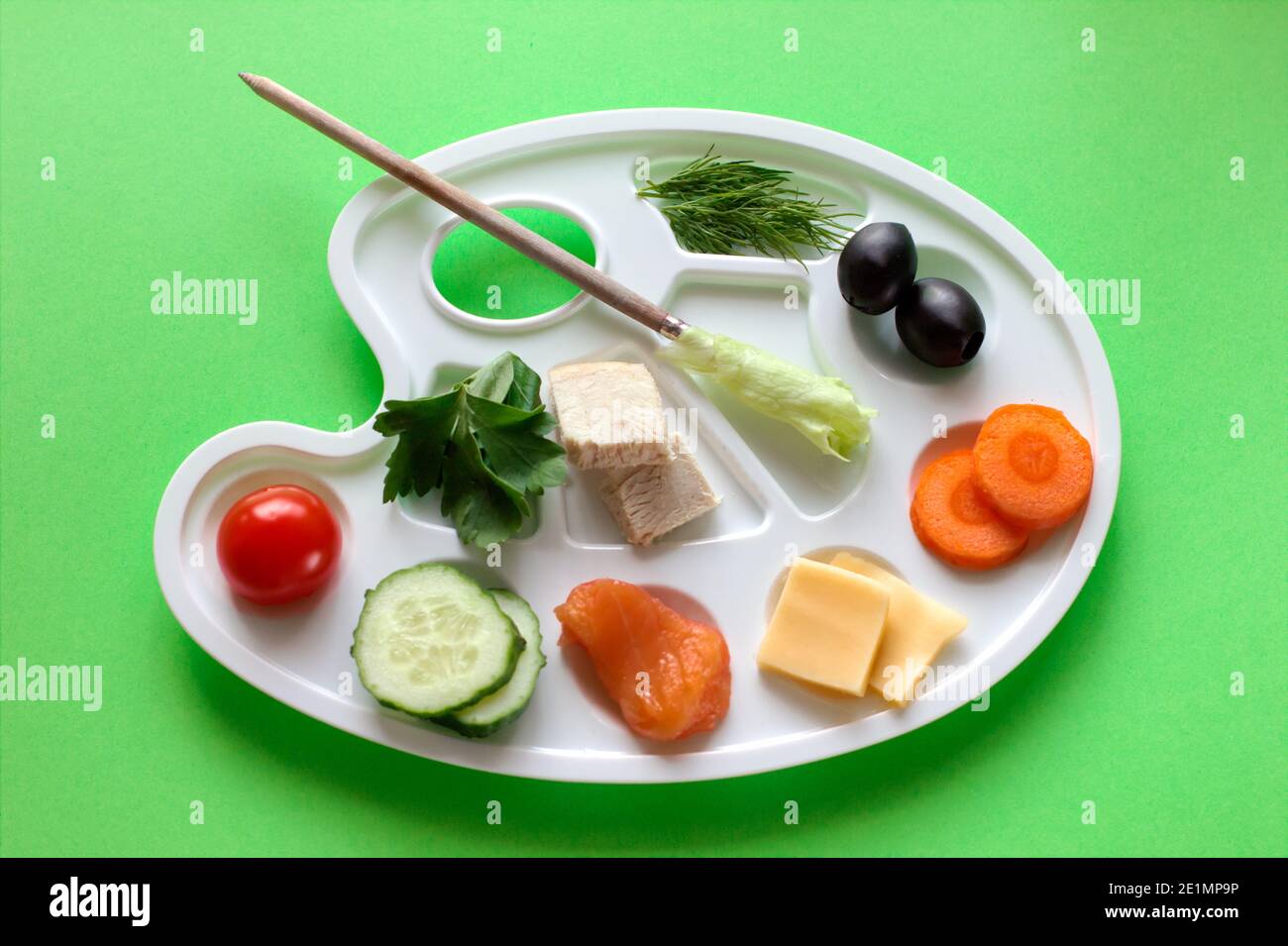 palette with tasty colorful vegetables, fish and greens, creative food ...