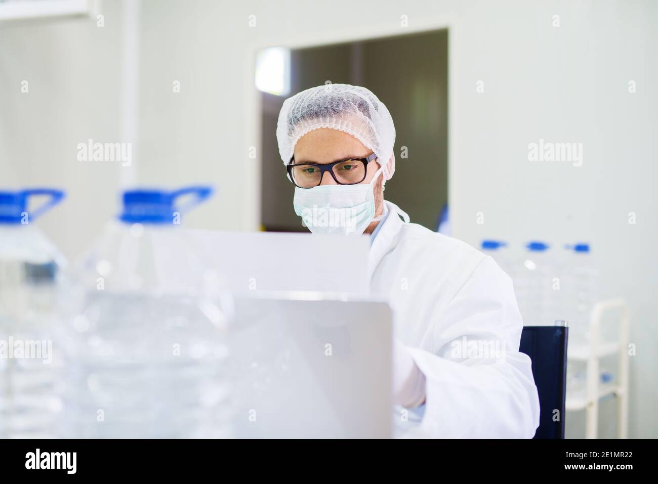 Hard working man in protective wear working in a laboratory Stock Photo ...