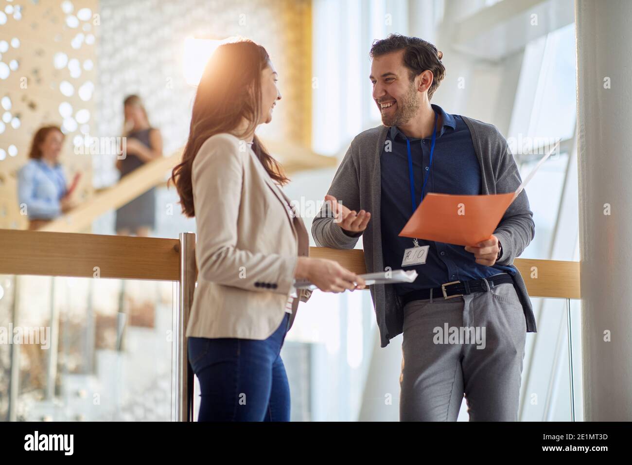 Group of job candidates talking and waiting for an interview in a ...