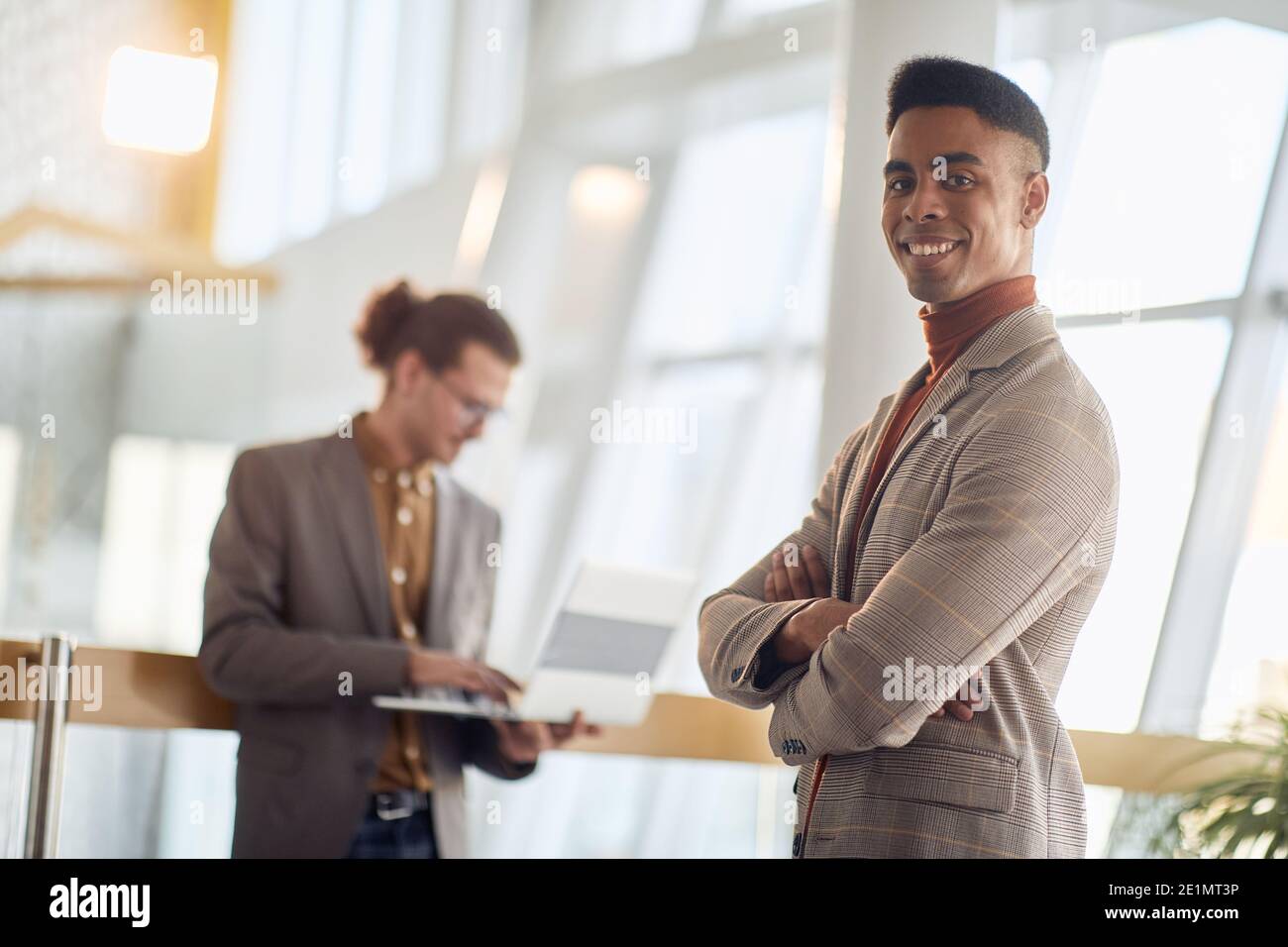 A young job candidate waiting for an interview and posing for a photo ...