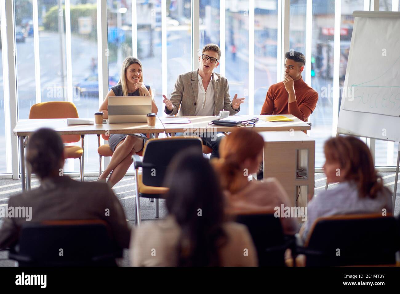 caucasian male boss giving a speech with management of the firm at ...