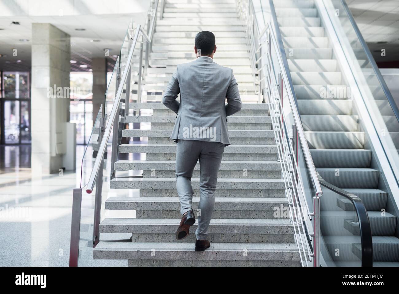 Businessman going up steps hi-res stock photography and images - Alamy